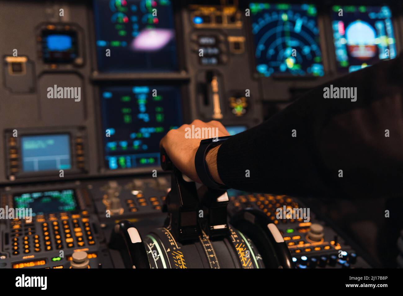 Pilot in illuminated cockpit flying airplane Stock Photo - Alamy