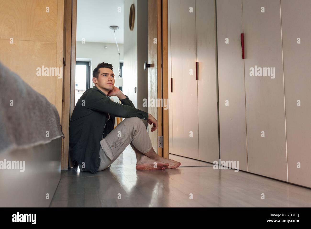 Young man sitting home hi-res stock photography and images - Alamy