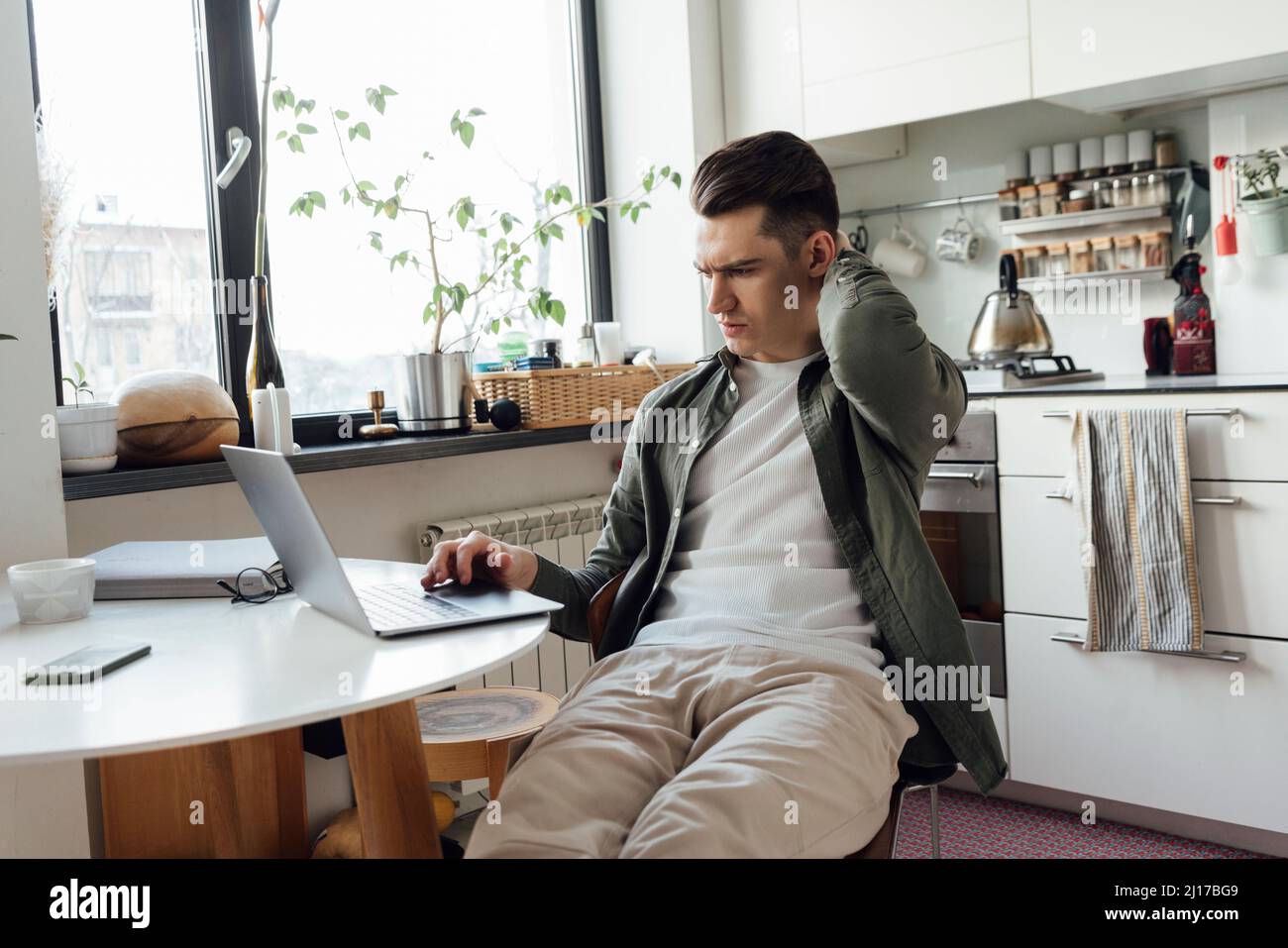 Young man behind table hi-res stock photography and images - Alamy