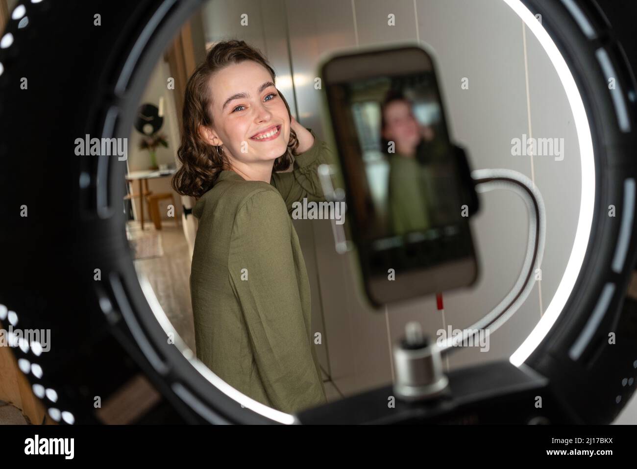 Smiling young vlogger filming tutorial at home Stock Photo - Alamy