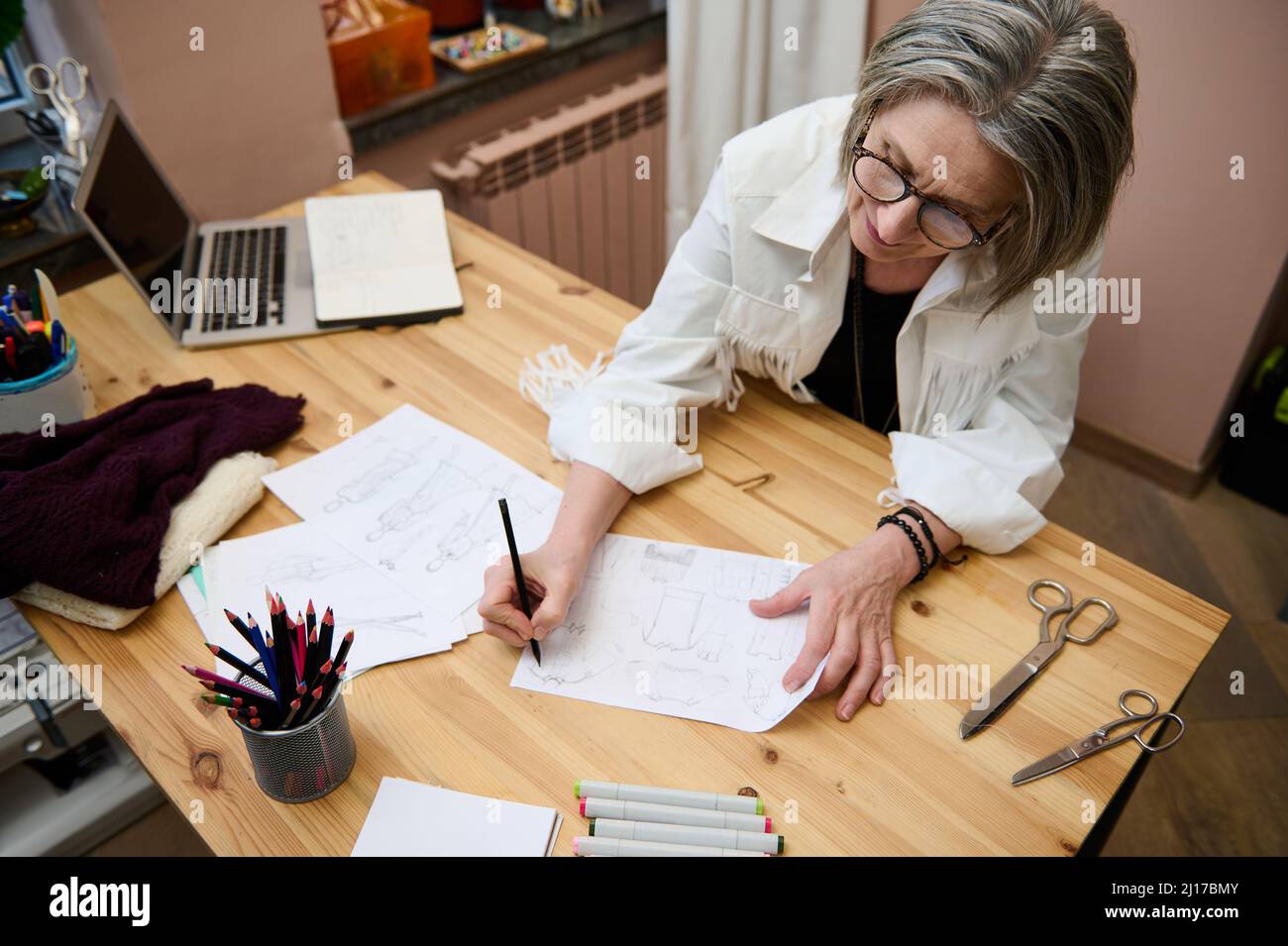Inspired stylish elderly Caucasian woman, fashion designer, dressmaker ...