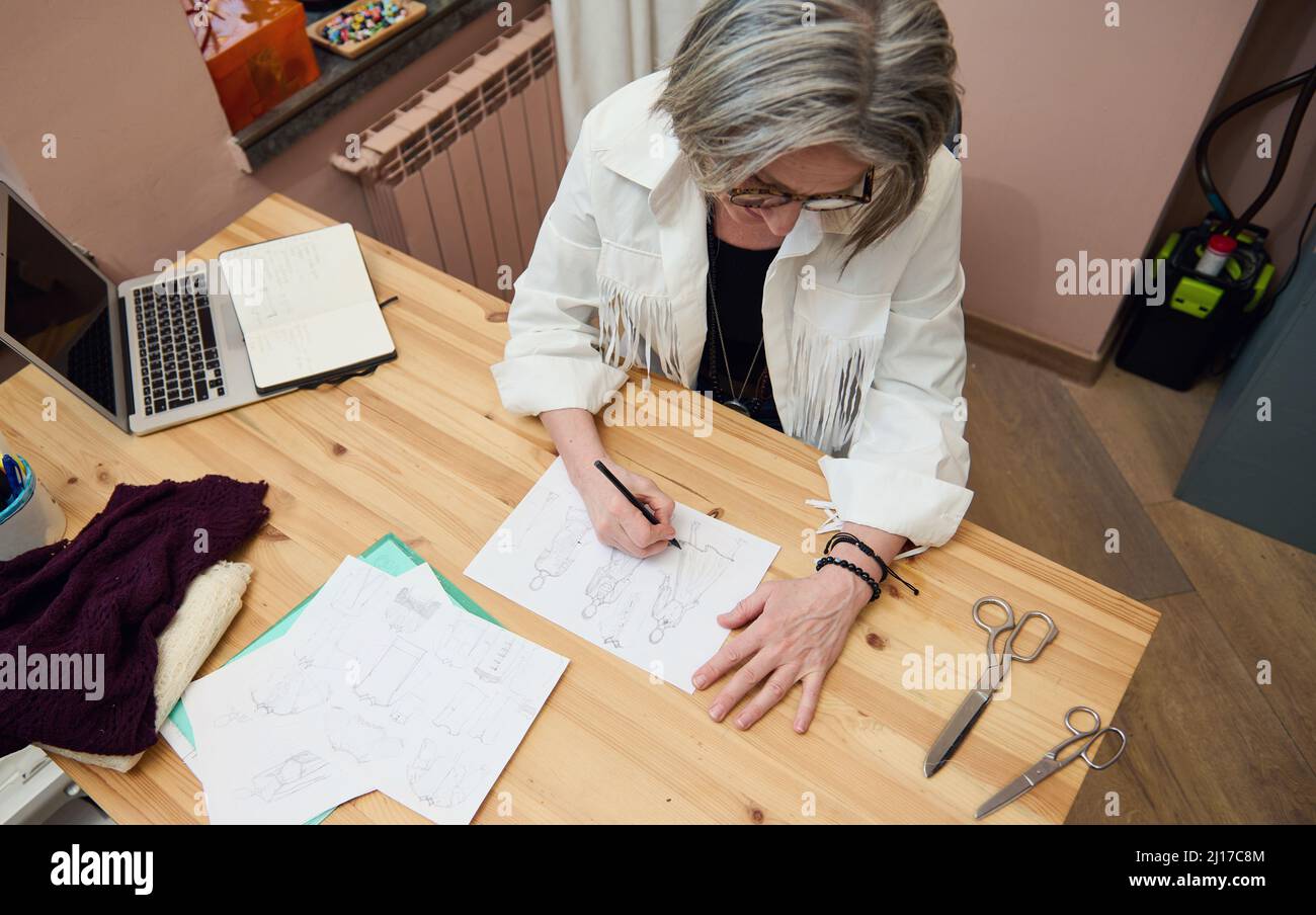 Tailor works sketches in workshop hi-res stock photography and images ...
