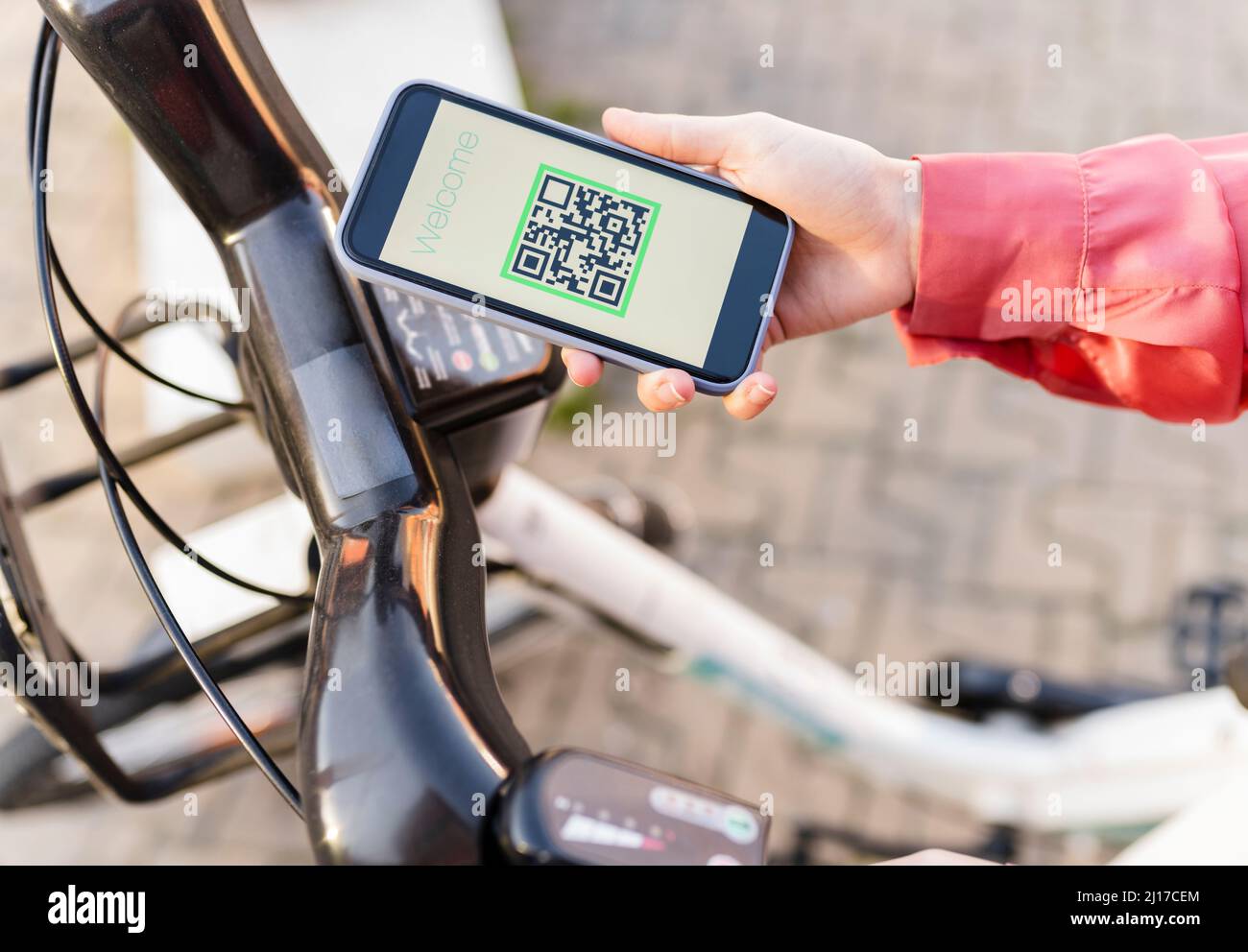 Woman scanning QR code through smart phone on electric bicycle Stock ...