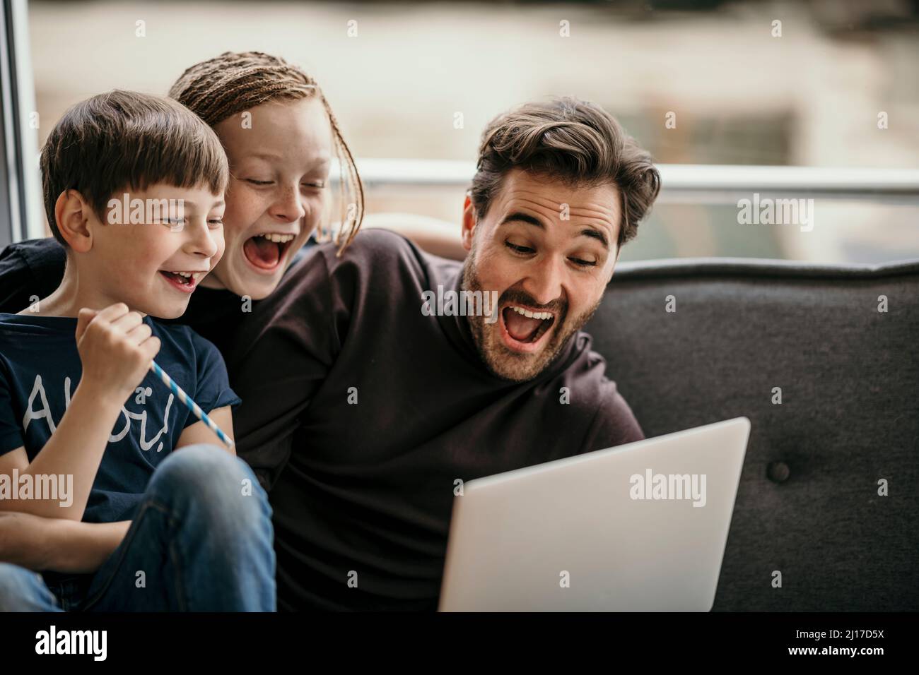 Laughing boys laptop hi-res stock photography and images - Alamy