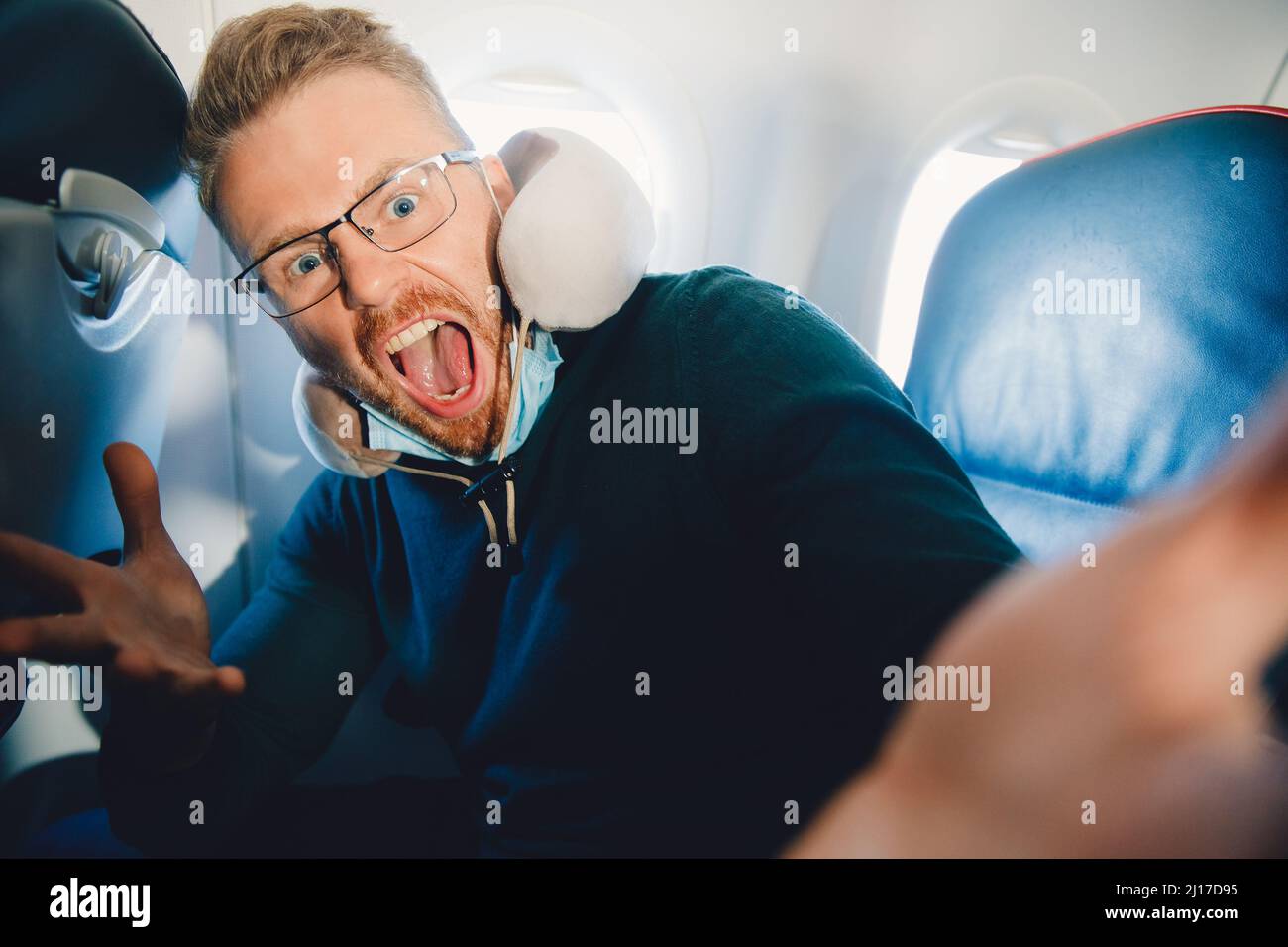 Concept of aerophobia, male tourist is afraid of flying on airplane ...