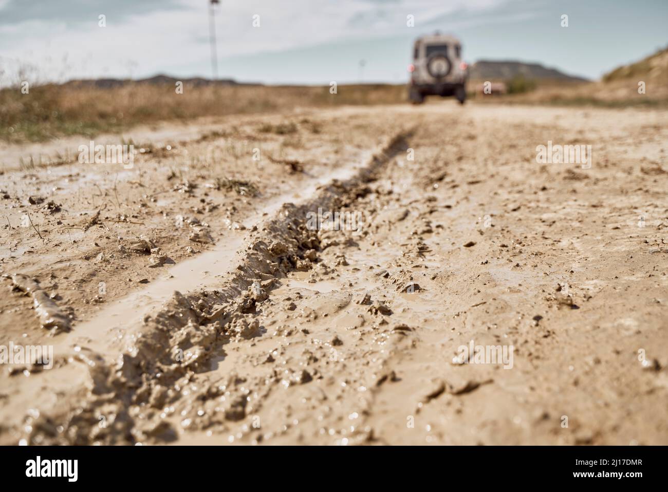 Wet tire track on muddy road Stock Photo - Alamy