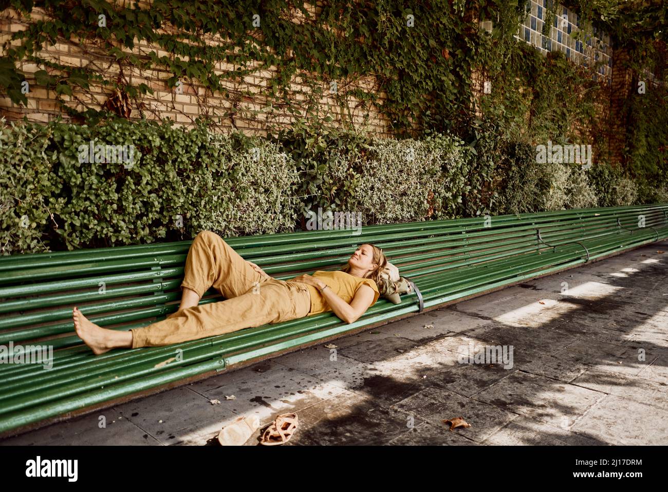 Woman resting in bench hi-res stock photography and images - Alamy