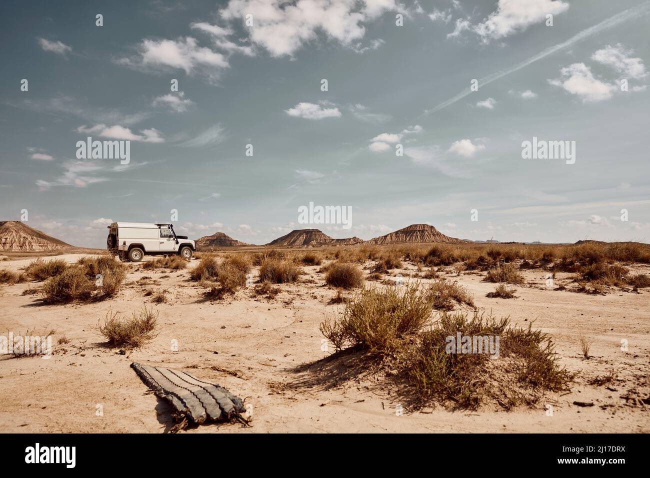 Car passing through off road in desert area at Bardenas Reales, Spain ...