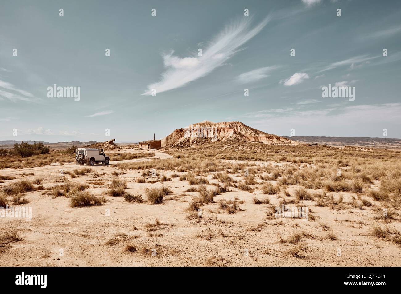 Car driving through desert road landscape bardenas reales hi-res stock ...