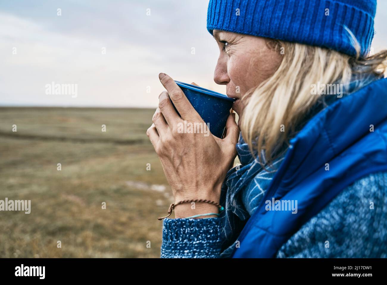 Tourist drinking coffee in mug Stock Photo - Alamy