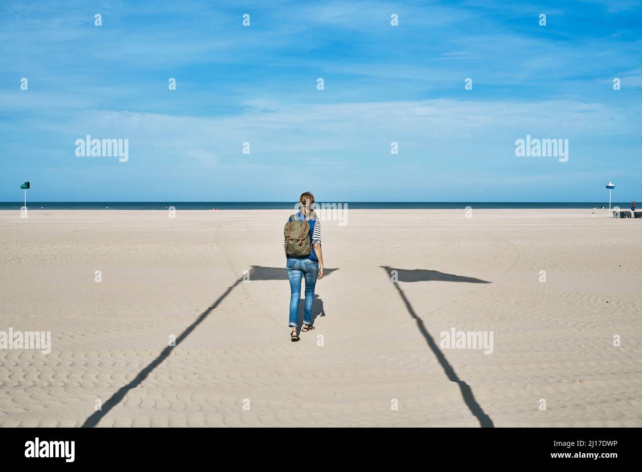 Tourist walking on sand at beach Stock Photo - Alamy