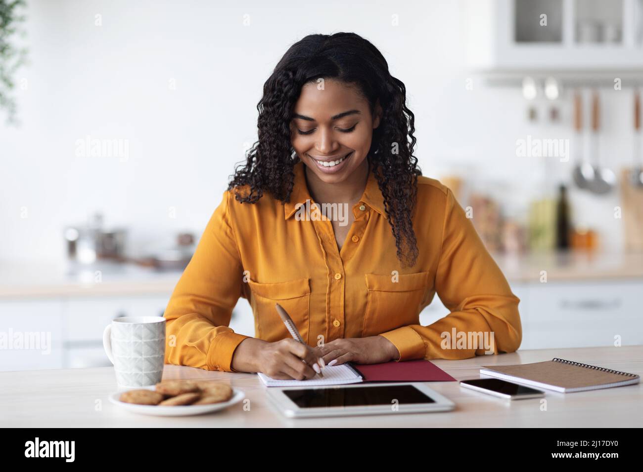 Woman working tablet taking notes hi-res stock photography and images ...