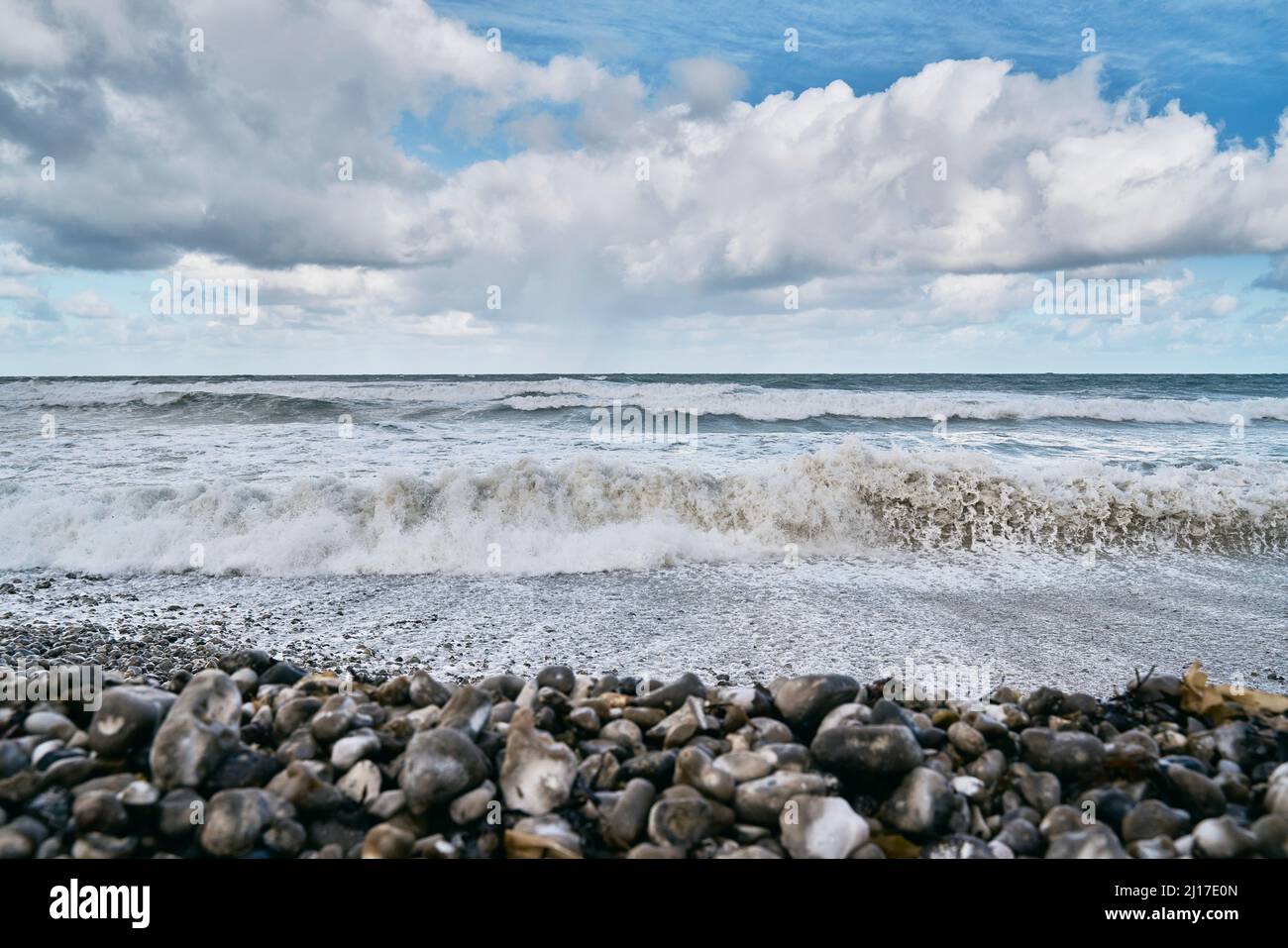 Sea waves splashing on pebbles at beach Stock Photo - Alamy