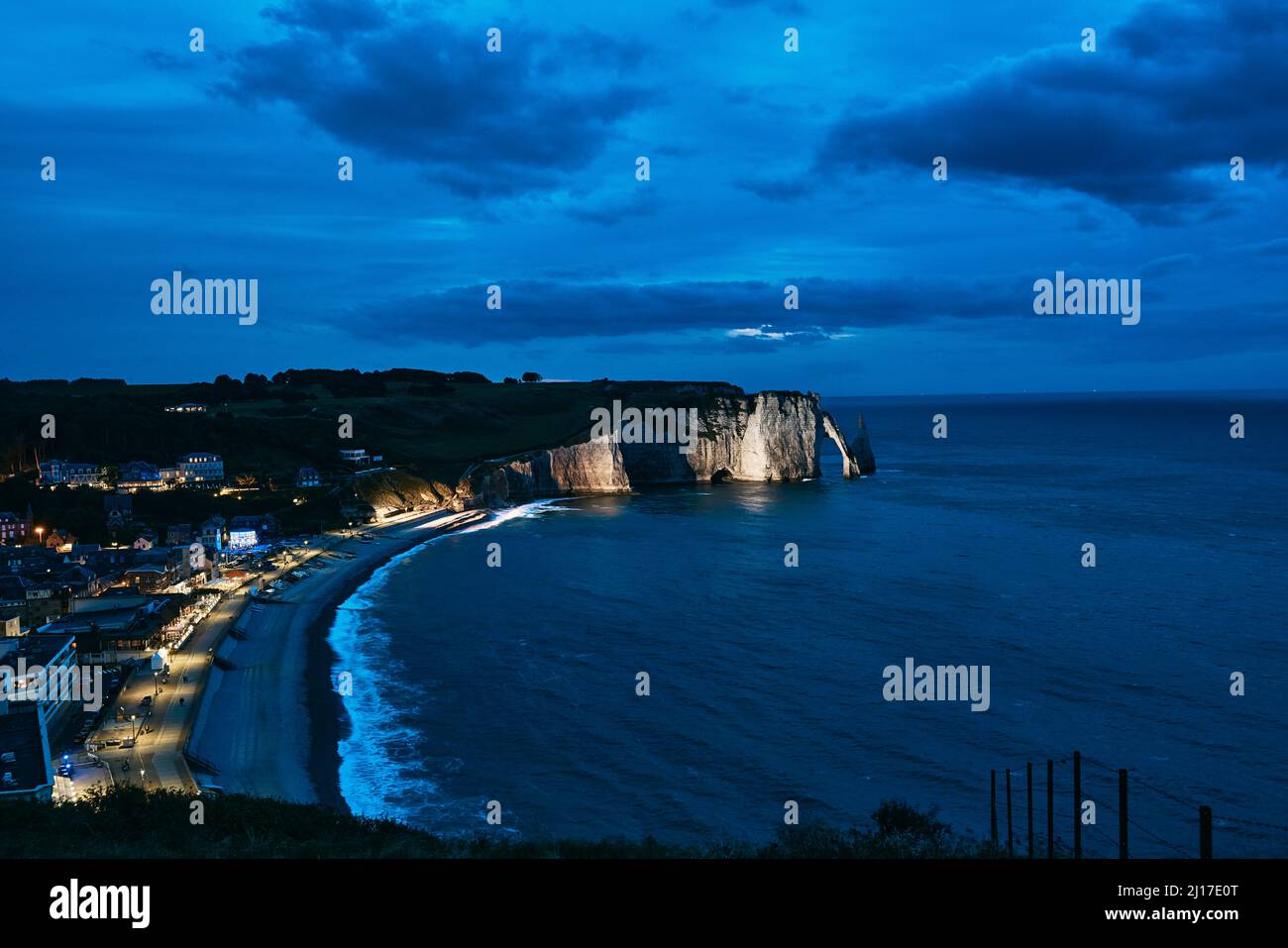 Town by beach coastline at night Stock Photo - Alamy