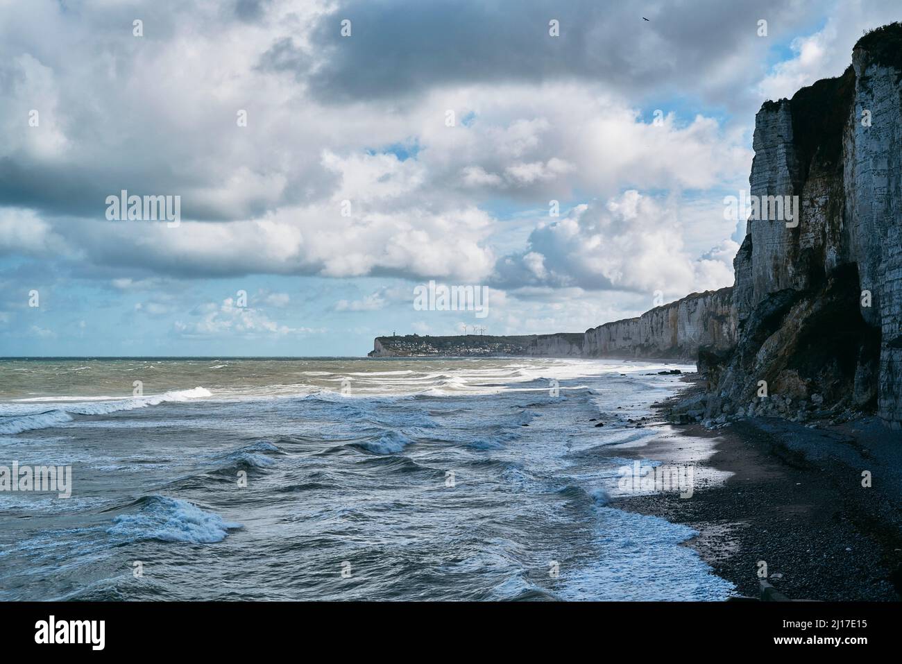 Waves splashing on cliff under cloudy sky Stock Photo - Alamy