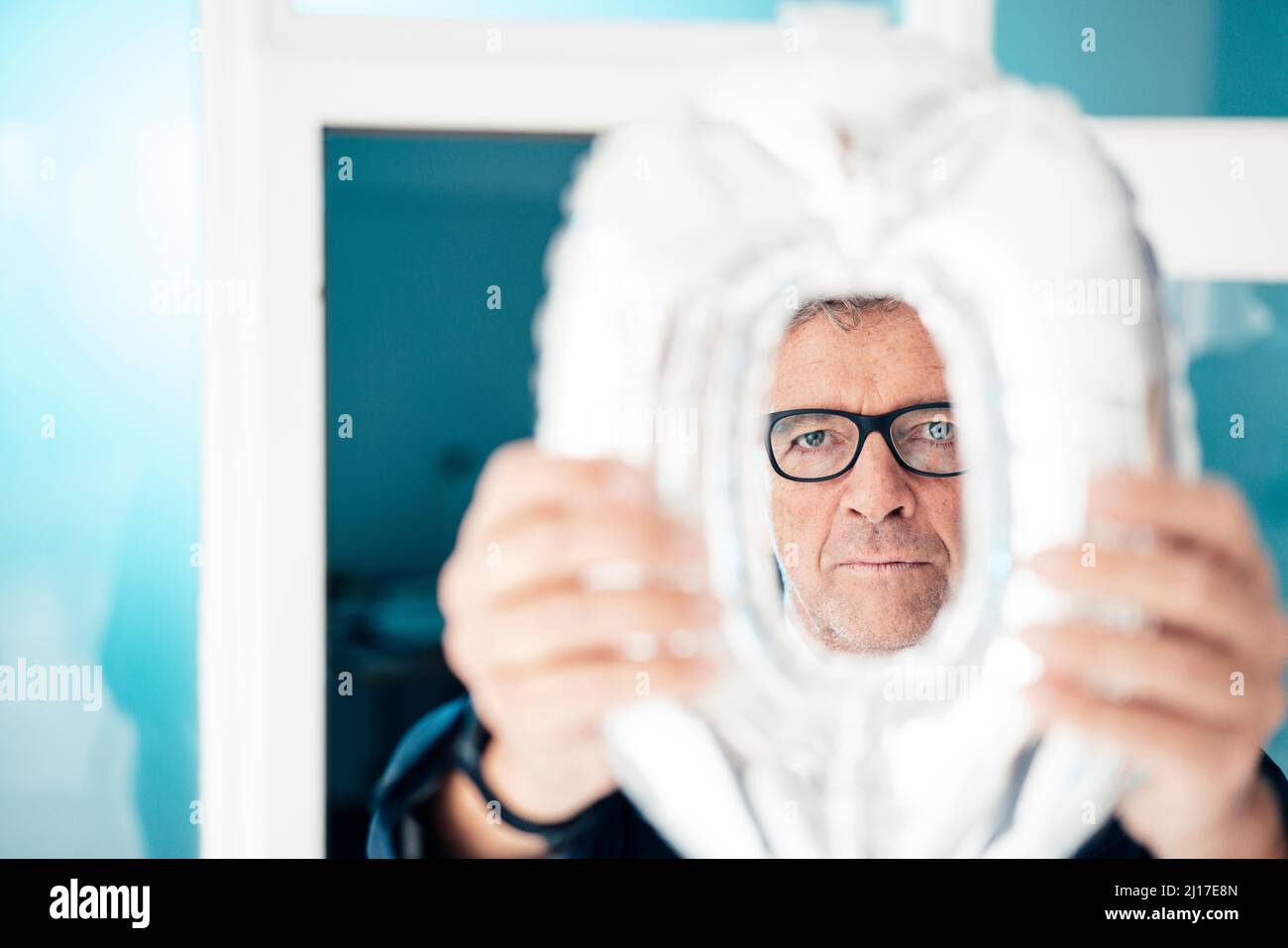Businessman with eyeglasses looking through object Stock Photo - Alamy