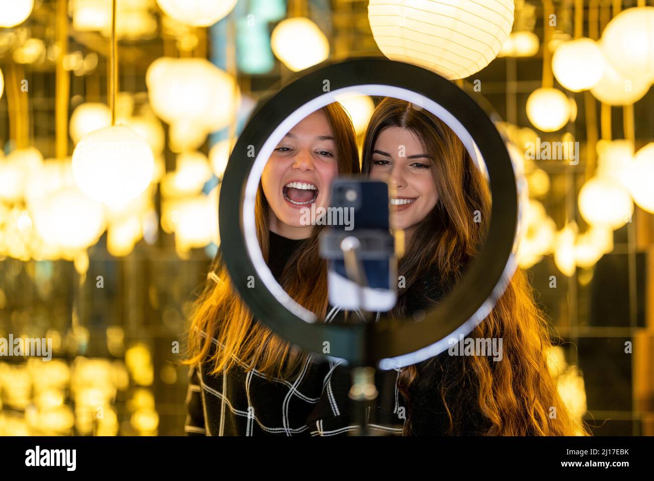 Influencer friends with ring light vlogging through smart phone Stock ...