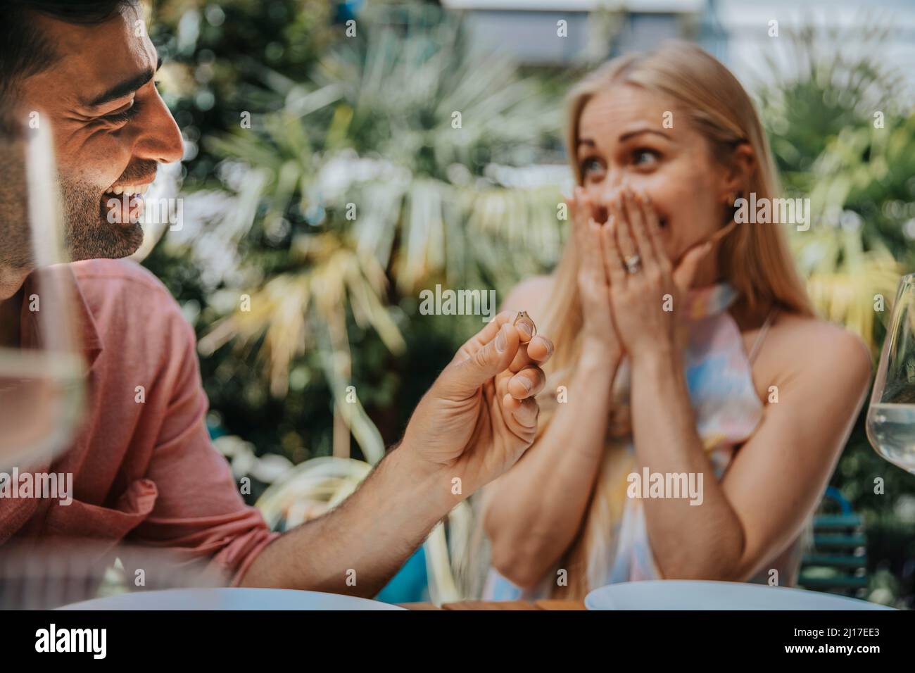 Happy man surprising woman with ring Stock Photo - Alamy