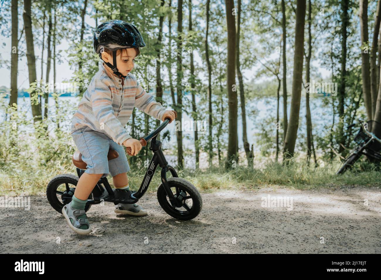 Cute boy cycling on road Stock Photo - Alamy