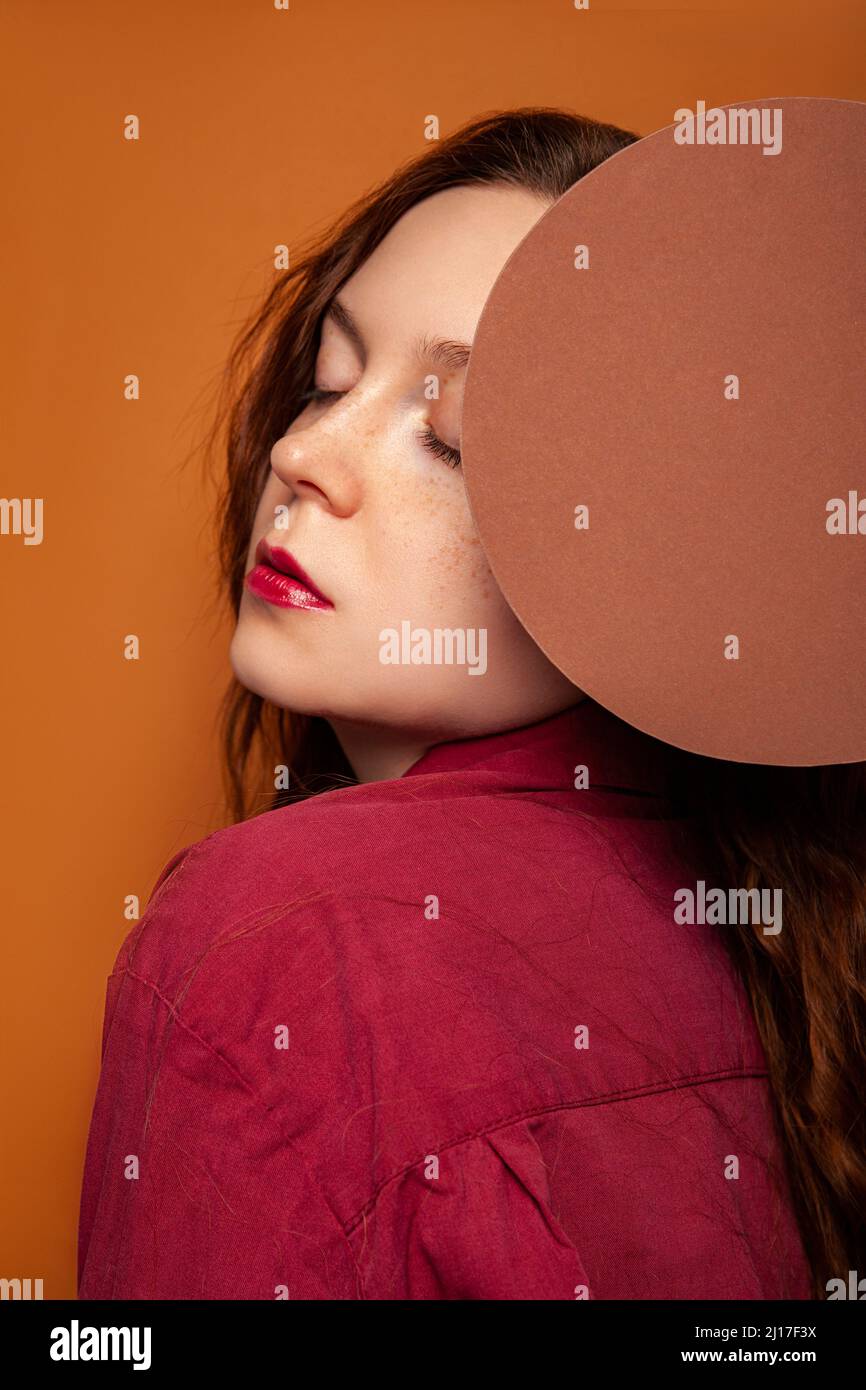 Beautiful woman posing with circle in studio Stock Photo - Alamy