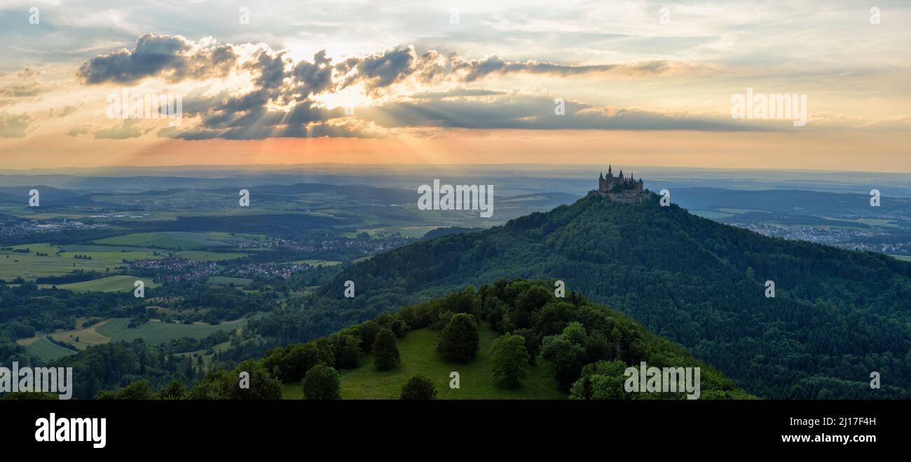 Germany, Baden-Wurttemberg, Hechingen, View of forested Hohenzollern mountain at summer sunset ...