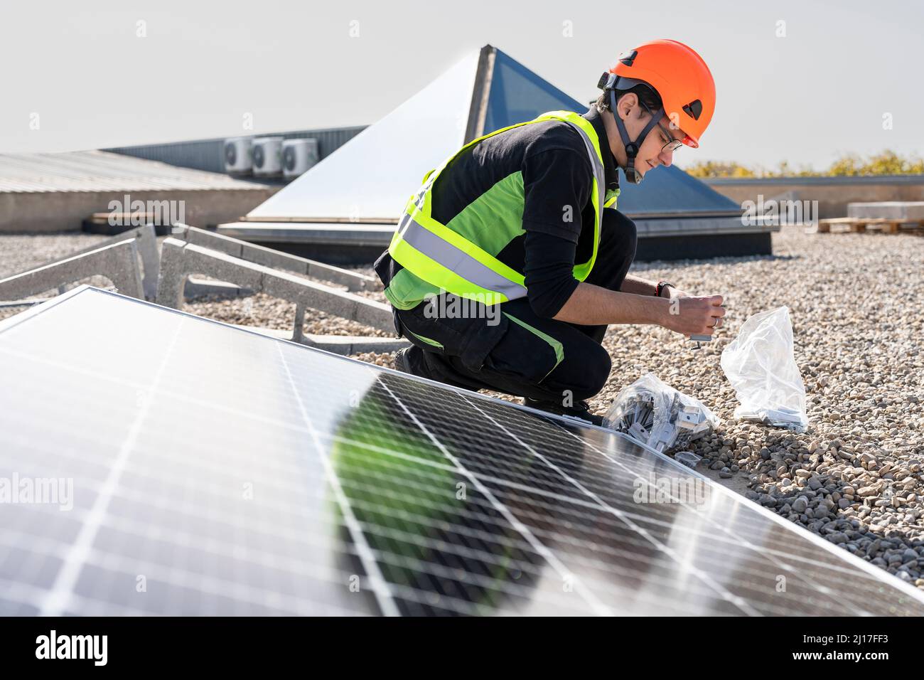 Technician assembling and installing solar panels on sunny day Stock ...