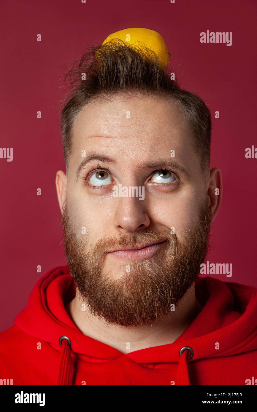 Man balancing lemon on head Stock Photo - Alamy