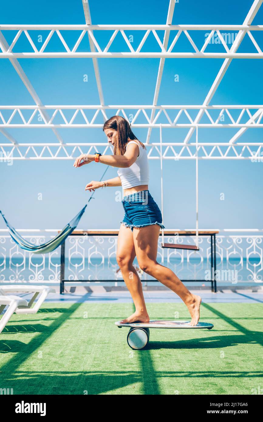 Woman balancing on board Stock Photo - Alamy