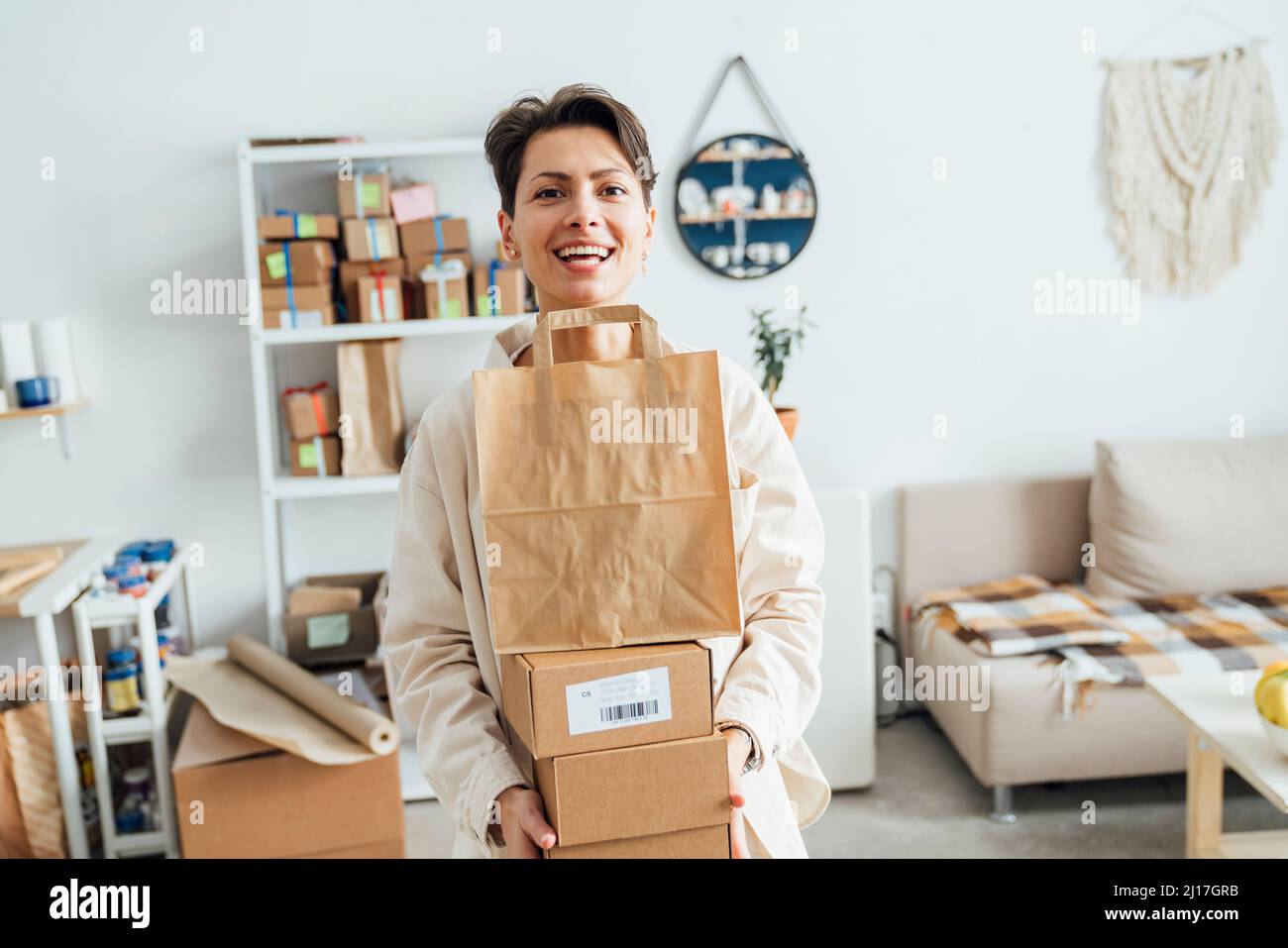 Woman carrying packages hi-res stock photography and images - Alamy