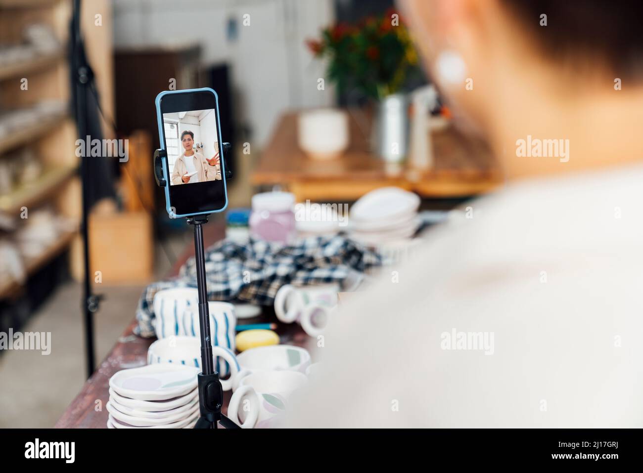 Influencer filming vlog through smart phone on tripod Stock Photo - Alamy