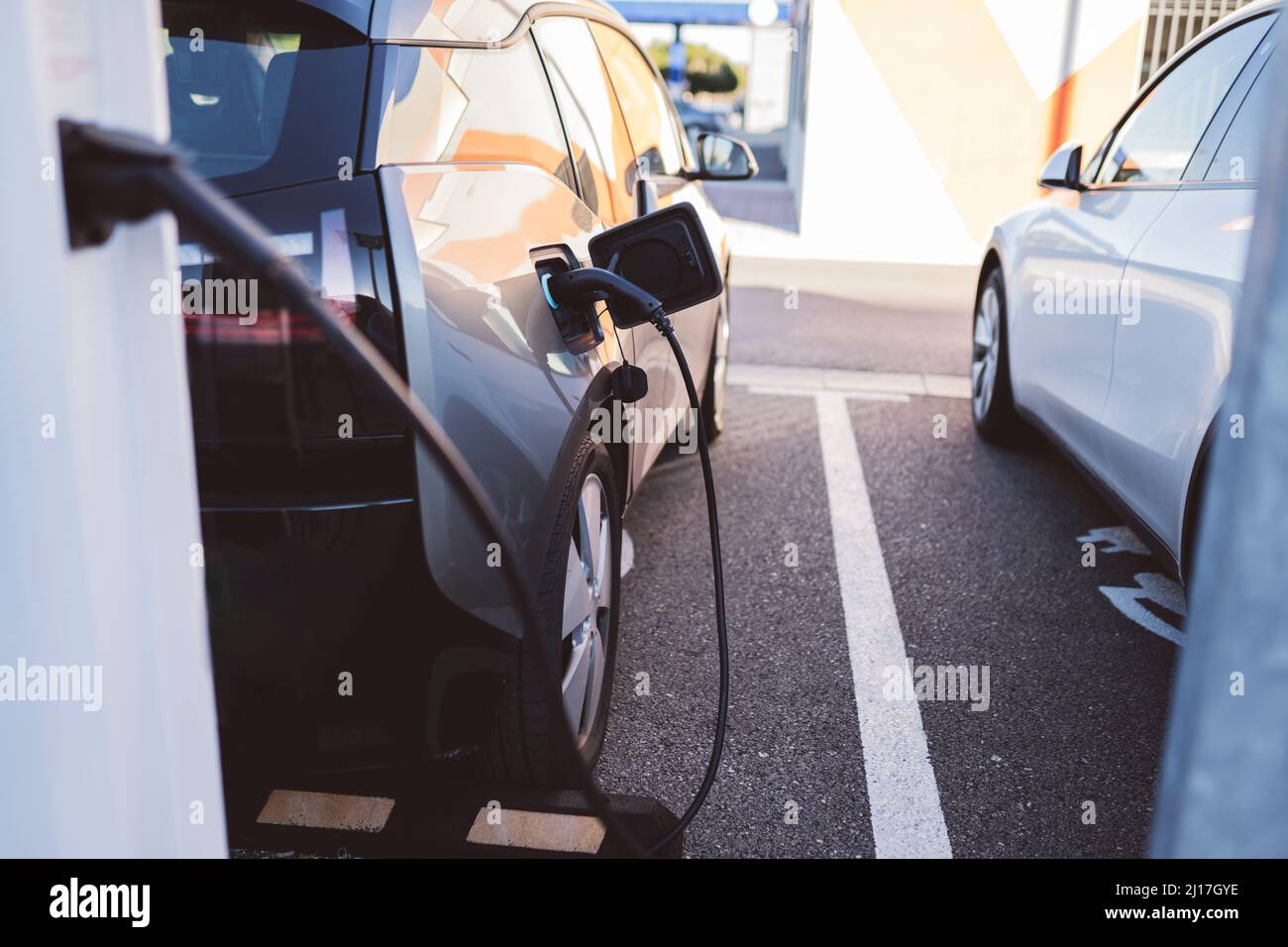 Electric car recharging in charging station Stock Photo - Alamy