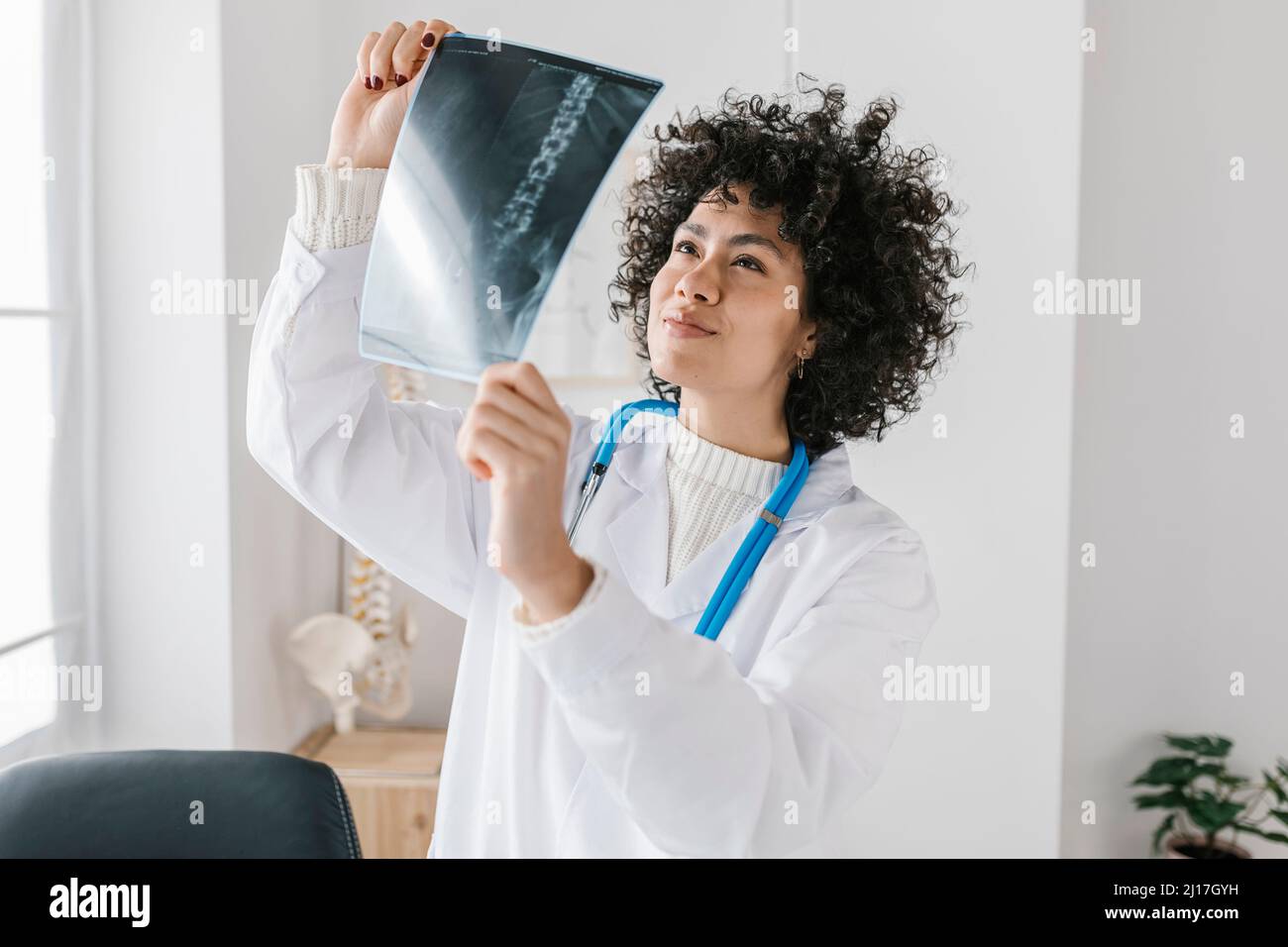 Doctor analyzing X-ray report at medical clinic Stock Photo - Alamy