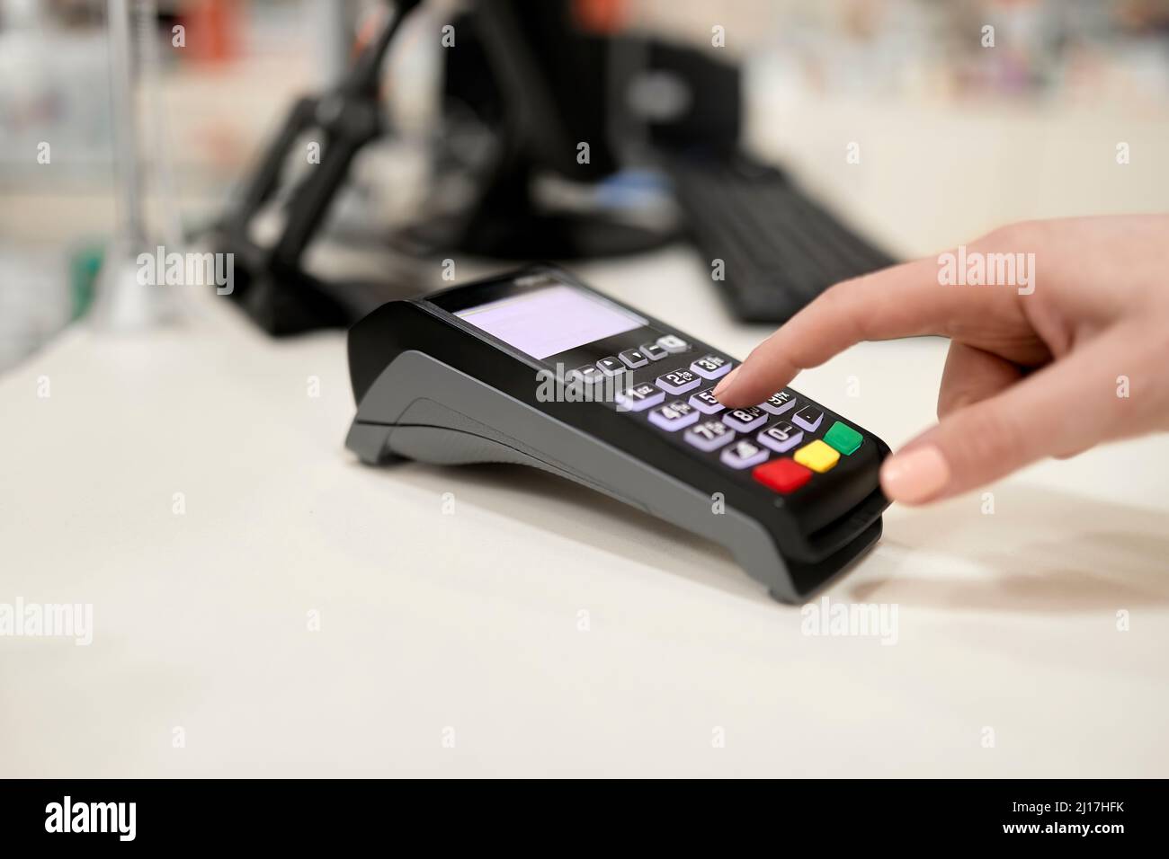 Hand using credit card reader at checkout counter in store Stock Photo ...