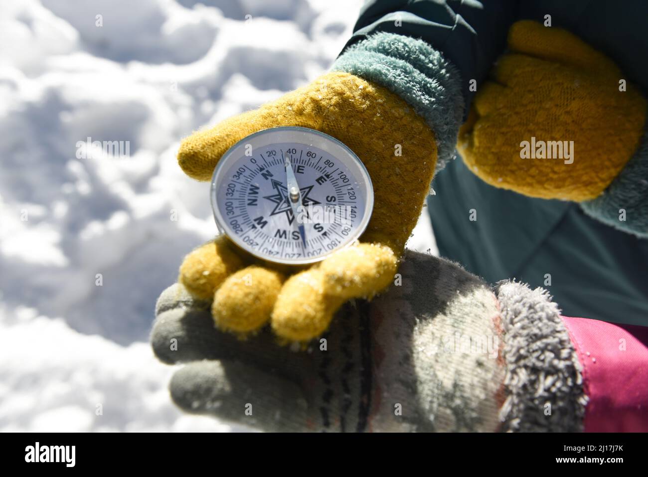 Hands of women wearing gloves holding navigational compass in winter ...