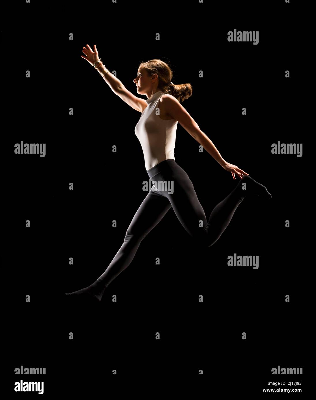 Woman jumping black background hi-res stock photography and images - Alamy