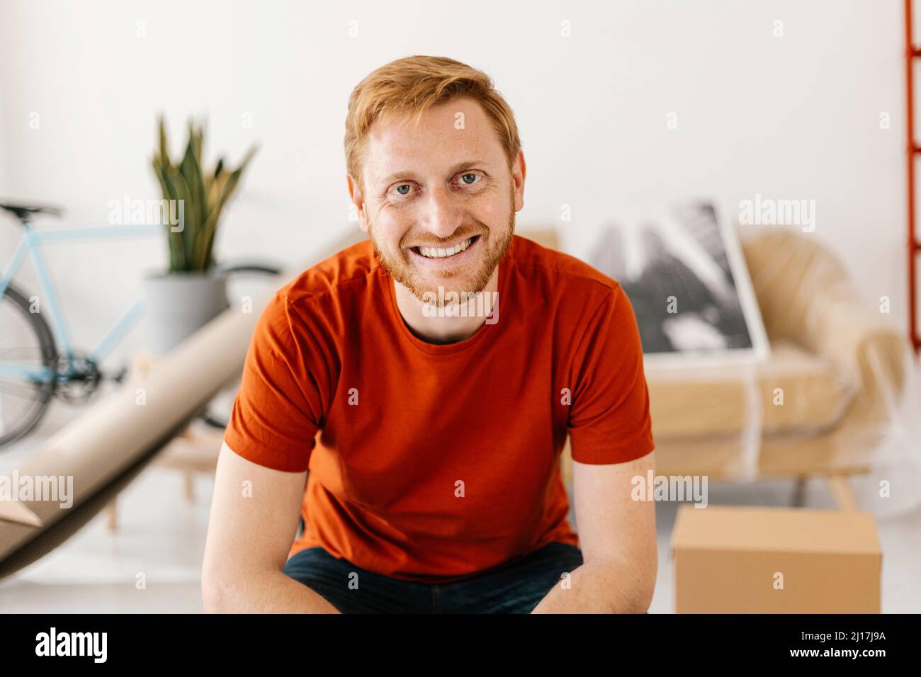 Young man sitting home hi-res stock photography and images - Alamy