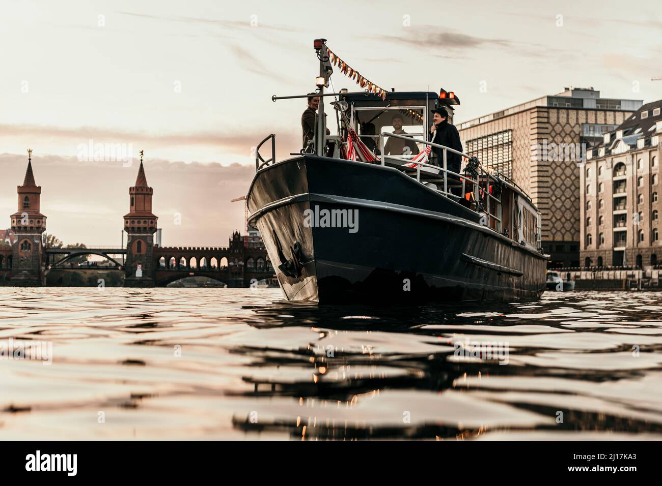 Friends on boat deck enjoying sunset Stock Photo - Alamy