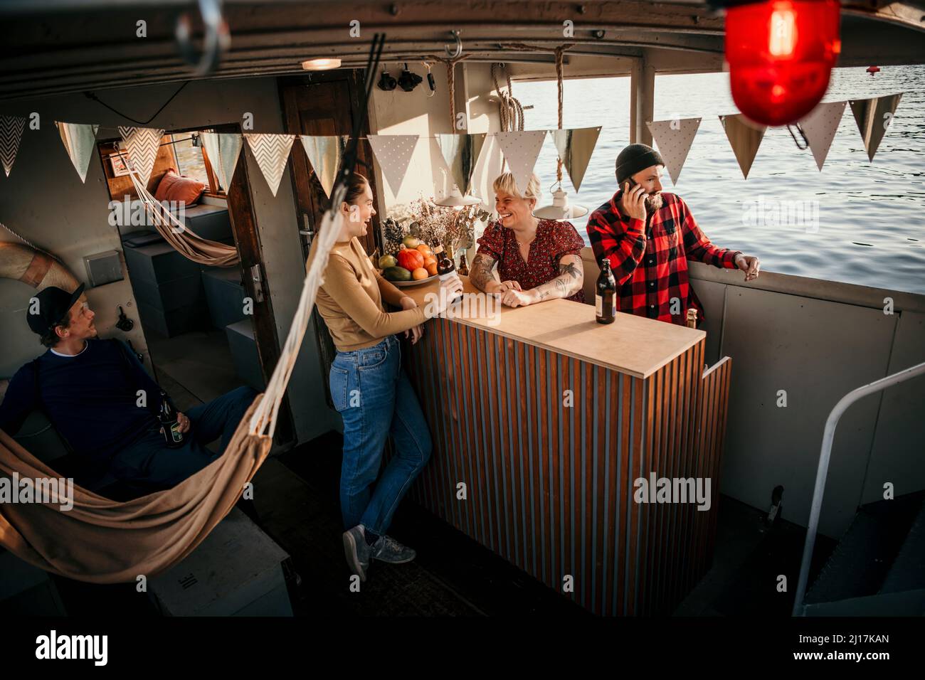 Happy friends spending leisure time together on boat Stock Photo - Alamy