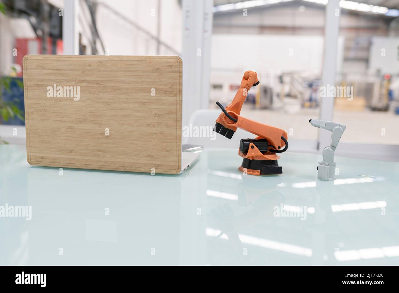 Robotic arm model by laptop on desk in factory Stock Photo - Alamy