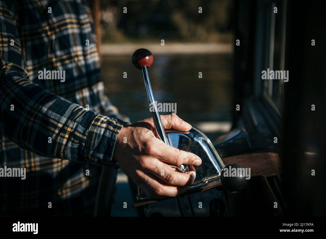 Hand of man controlling lever of boat Stock Photo - Alamy