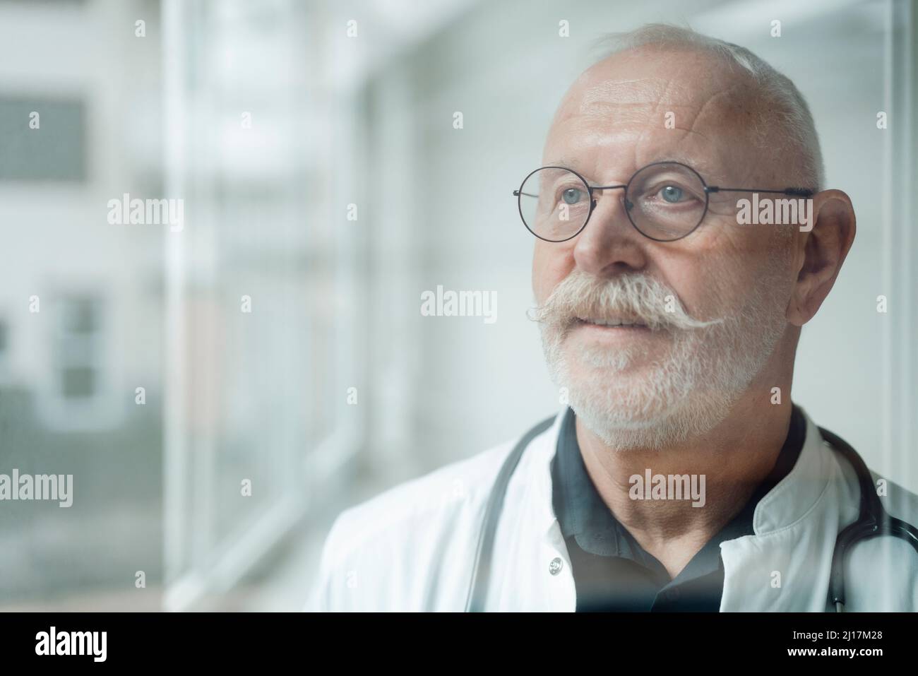 Thoughtful doctor with mustache at hospital Stock Photo - Alamy