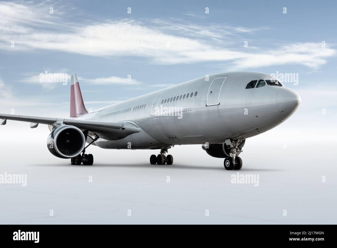 White wide body passenger airliner isolated on bright background with ...