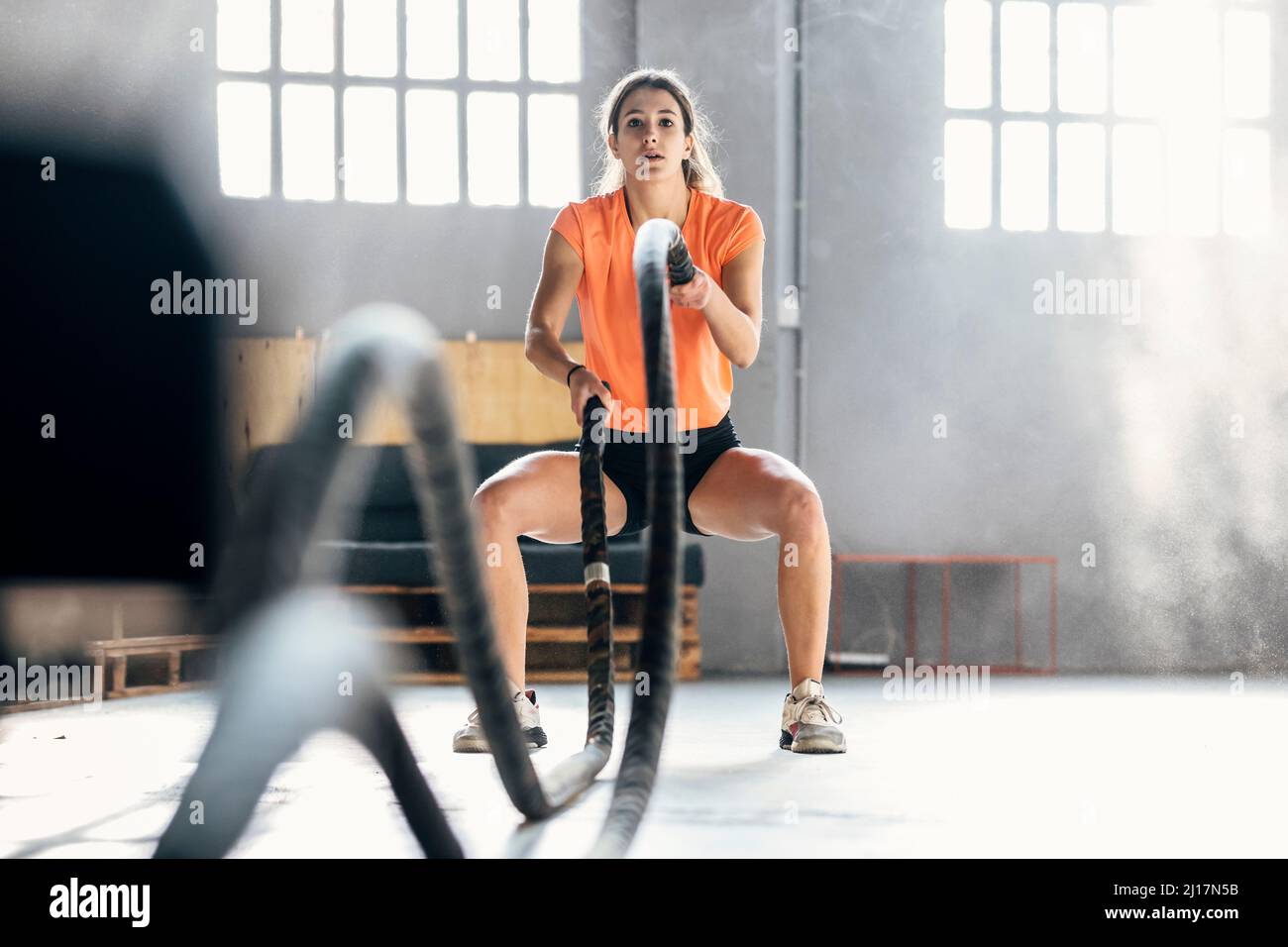 Woman battle rope in gym hi-res stock photography and images - Alamy