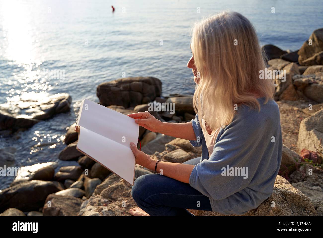 Woman book on rock hi-res stock photography and images - Alamy