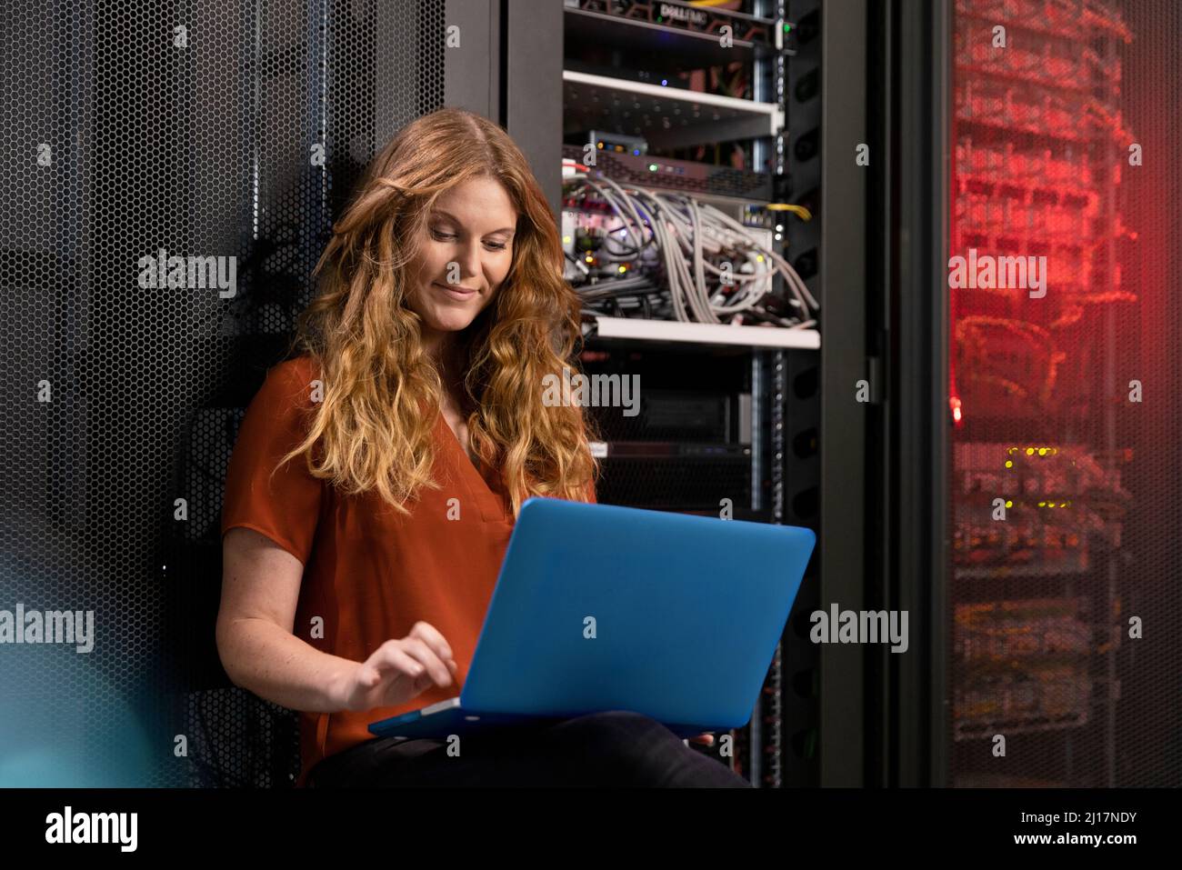 Smiling data center programmer using hi-res stock photography and ...