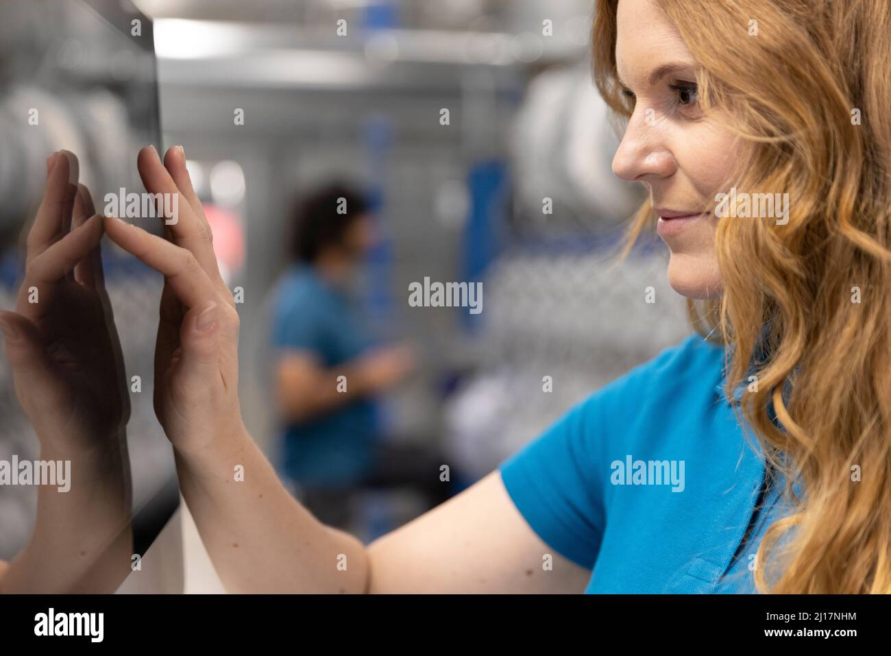 Technician using touch screen device in factory Stock Photo - Alamy