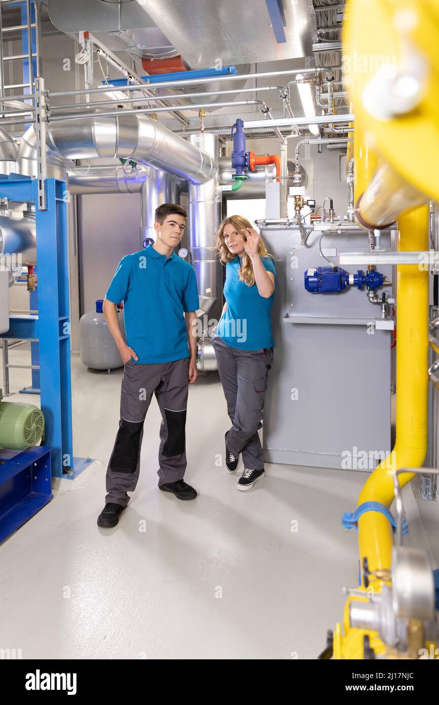 Technician explaining about machine to trainee in factory Stock Photo ...