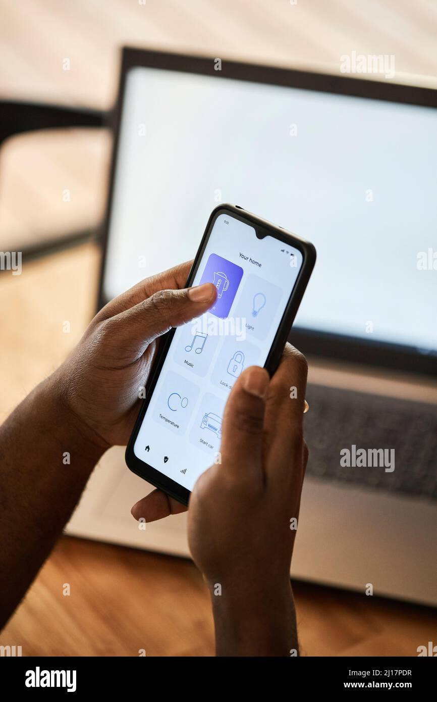 Man using home automation app on smart phone Stock Photo - Alamy