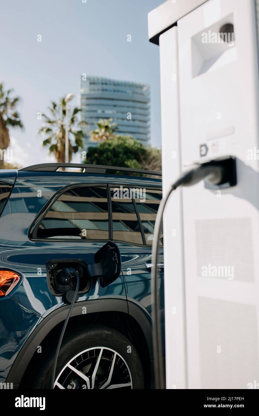 Electric car being charged at charging station Stock Photo - Alamy