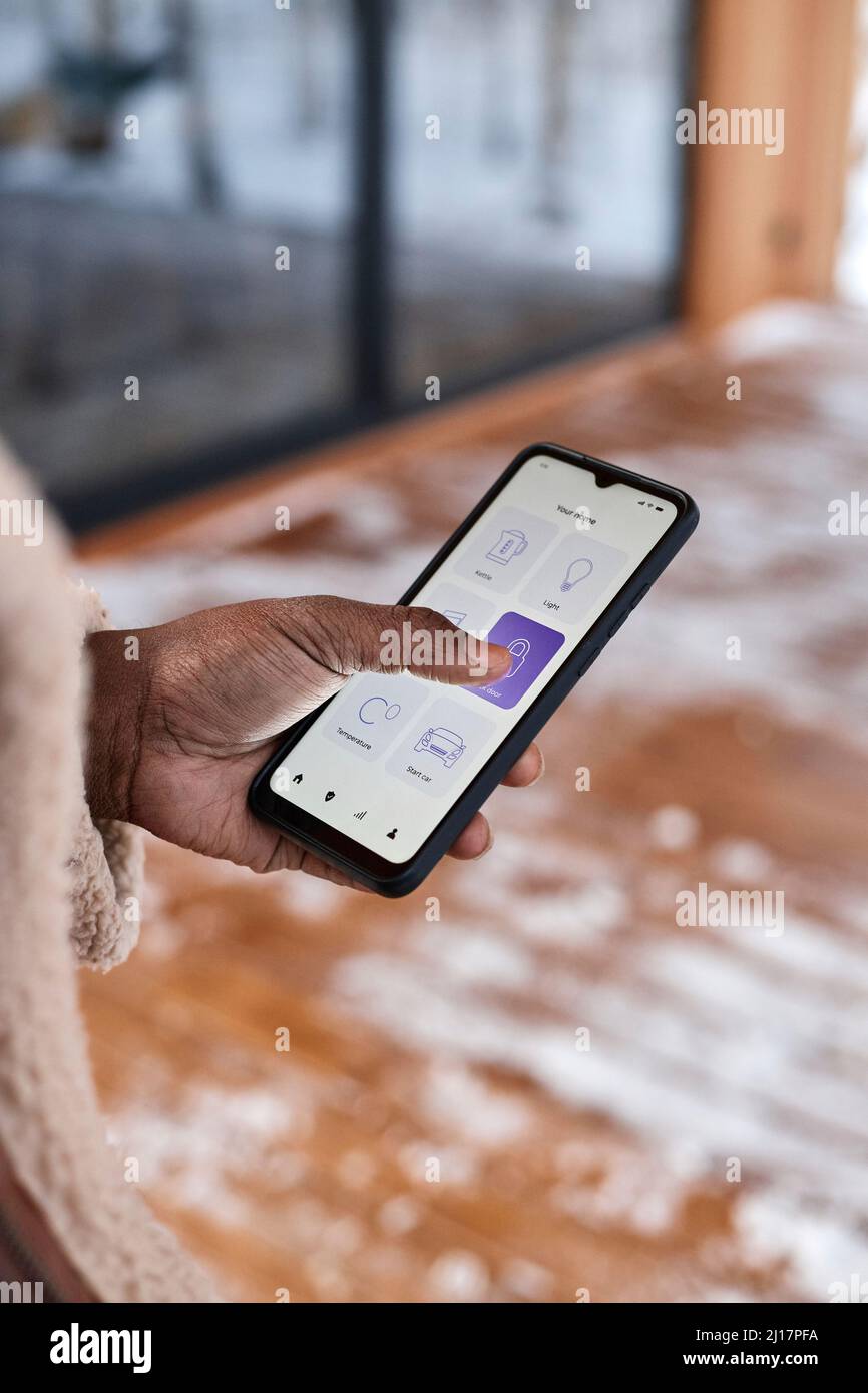 Man locking door of house using app on smart phone Stock Photo - Alamy